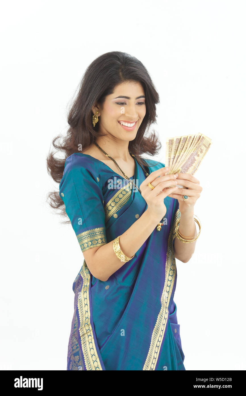 Woman holding hundred rupees hi-res stock photography and images - Alamy