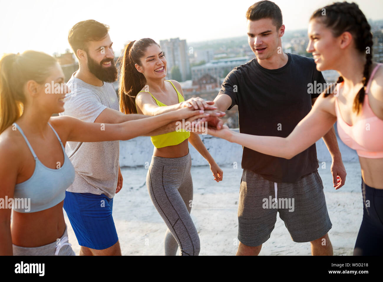 Group of young happy people friends exercising outdoors at sunset Stock ...