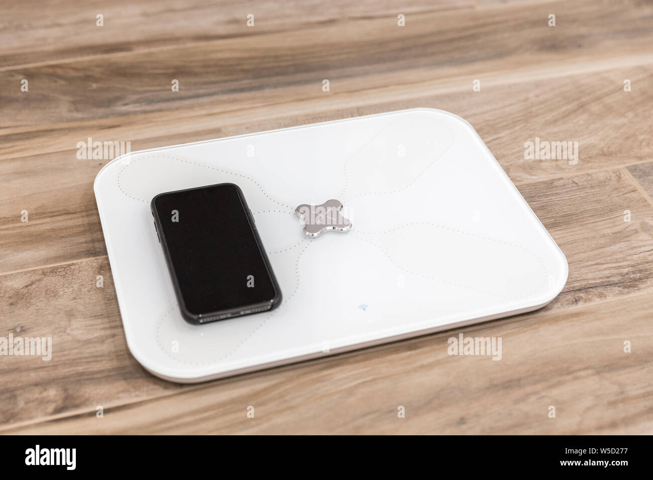 Smart scale standing on a floor connected to smartphone Stock Photo - Alamy