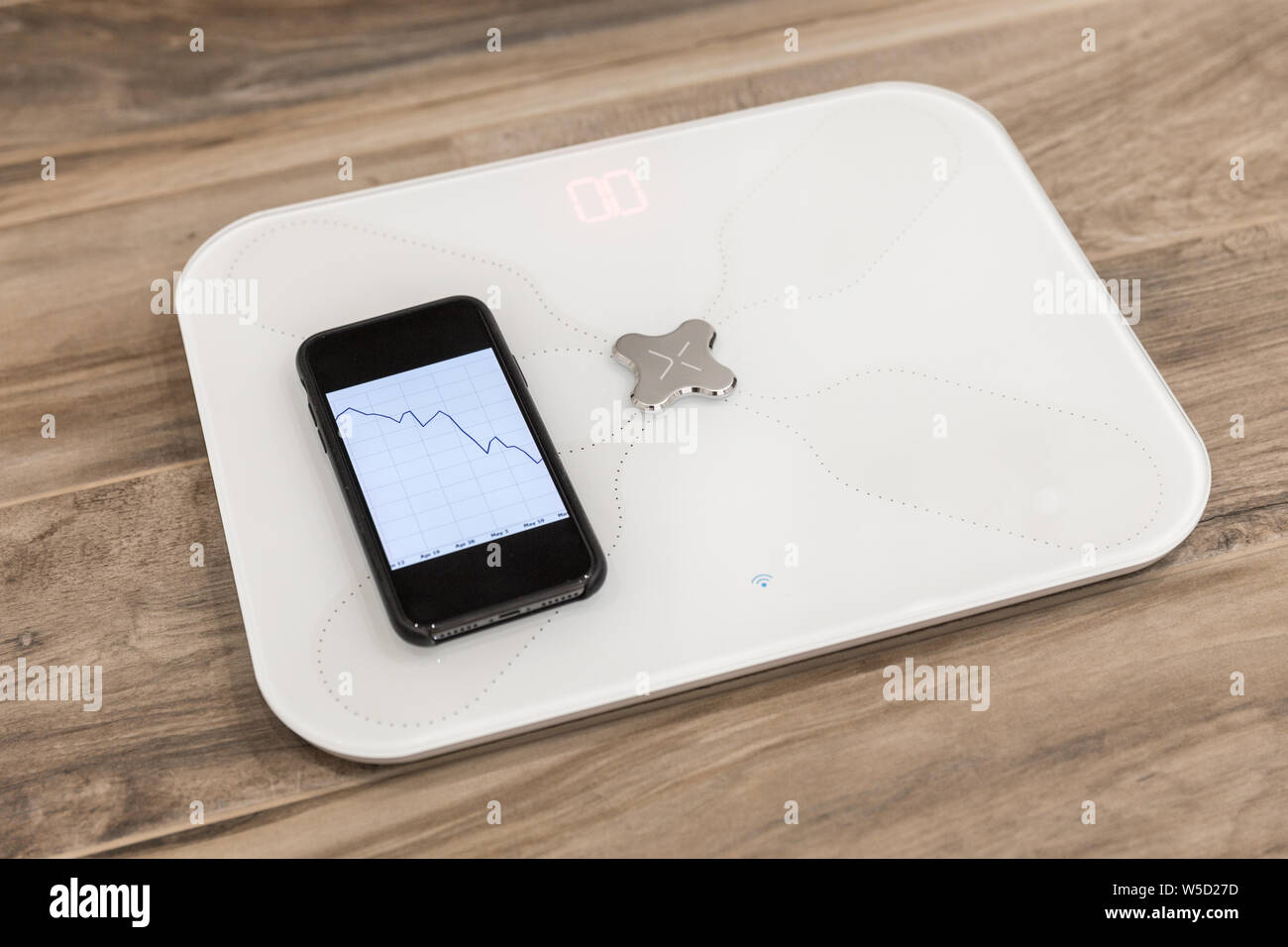Smart scale standing on a floor connected to smartphone Stock Photo - Alamy