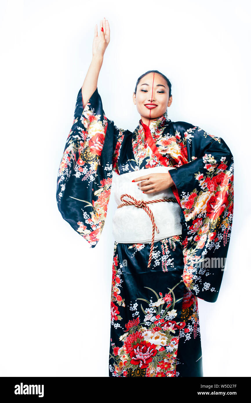 young pretty real geisha in kimono with sakura and decoration on white ...