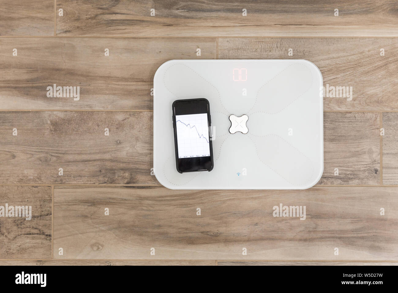 Smart scale standing on a floor connected to smartphone Stock Photo - Alamy