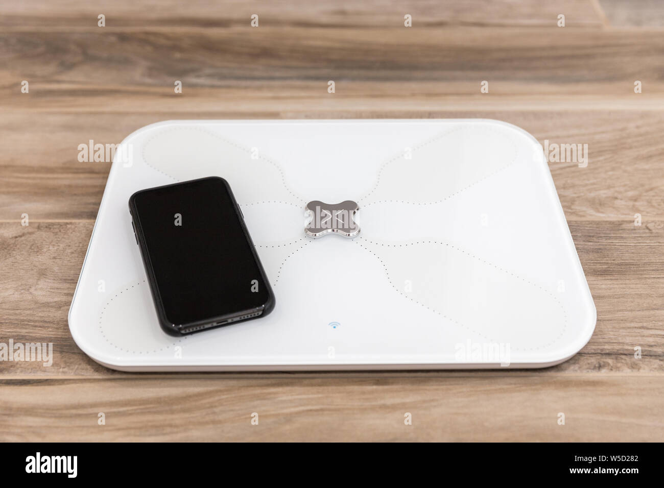 Smart scale standing on a floor connected to smartphone Stock Photo - Alamy