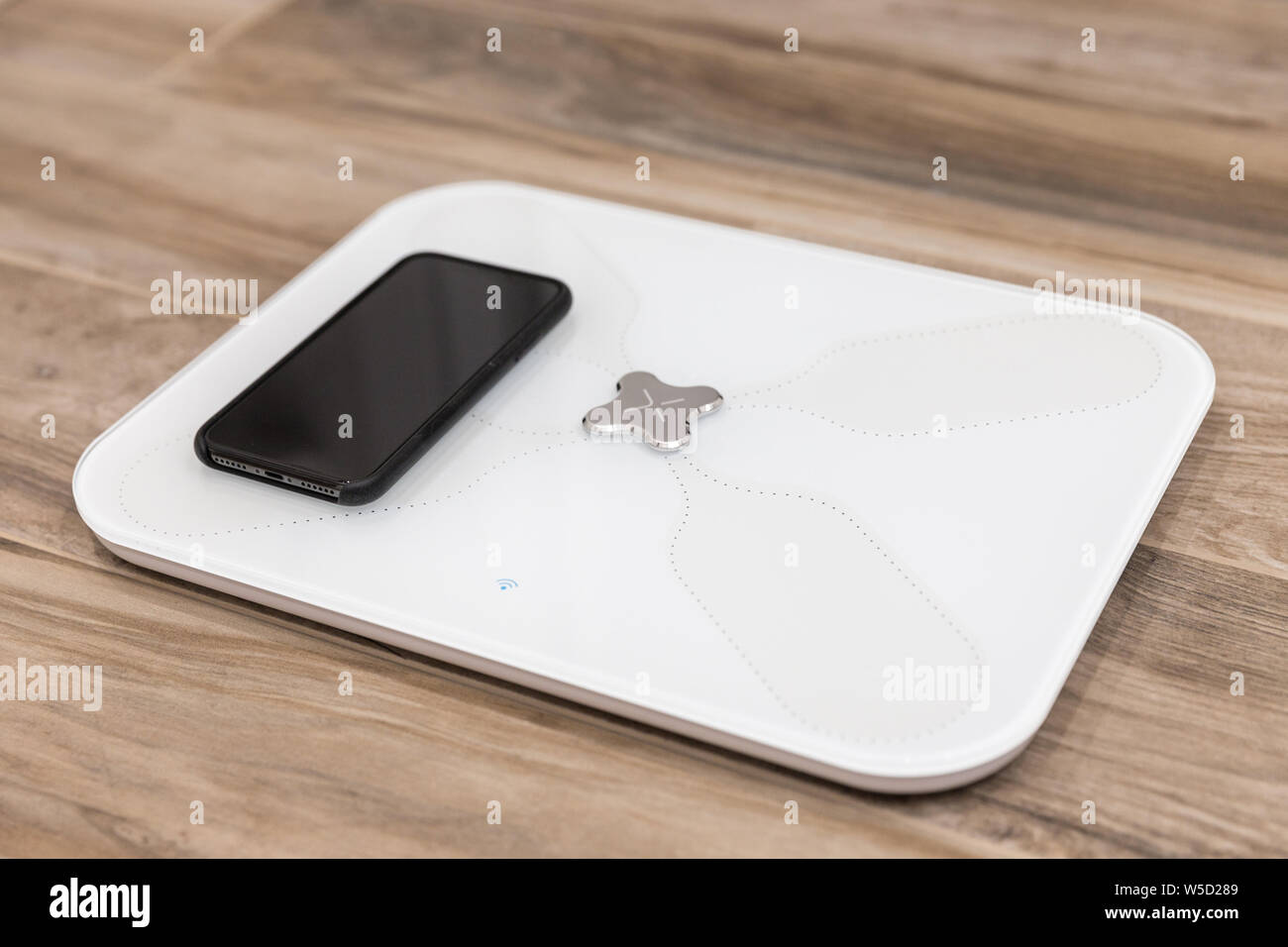 Smart scale standing on a floor connected to smartphone Stock Photo - Alamy