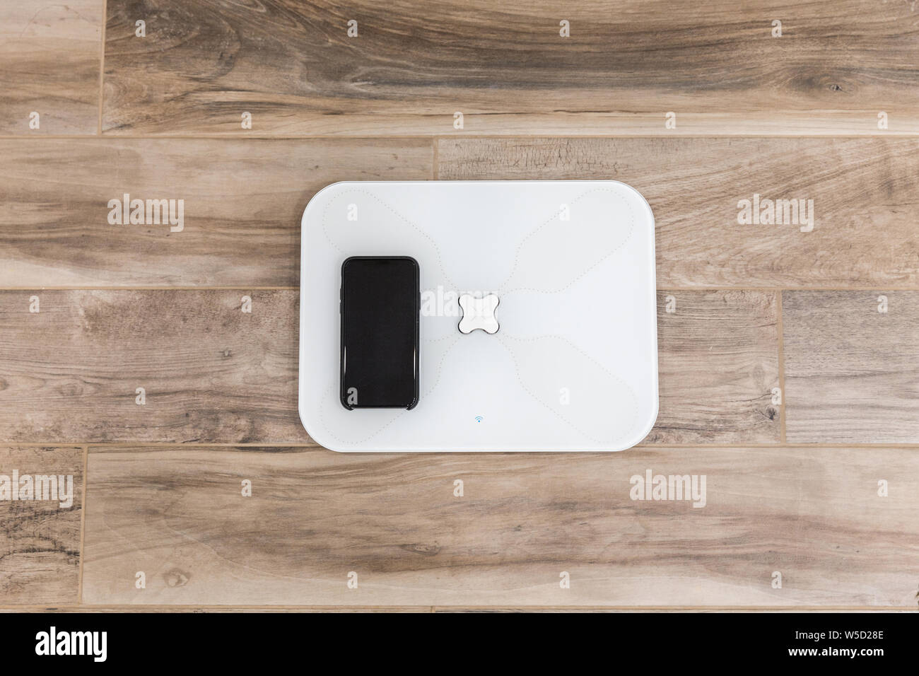 Smart scale standing on a floor connected to smartphone Stock Photo - Alamy