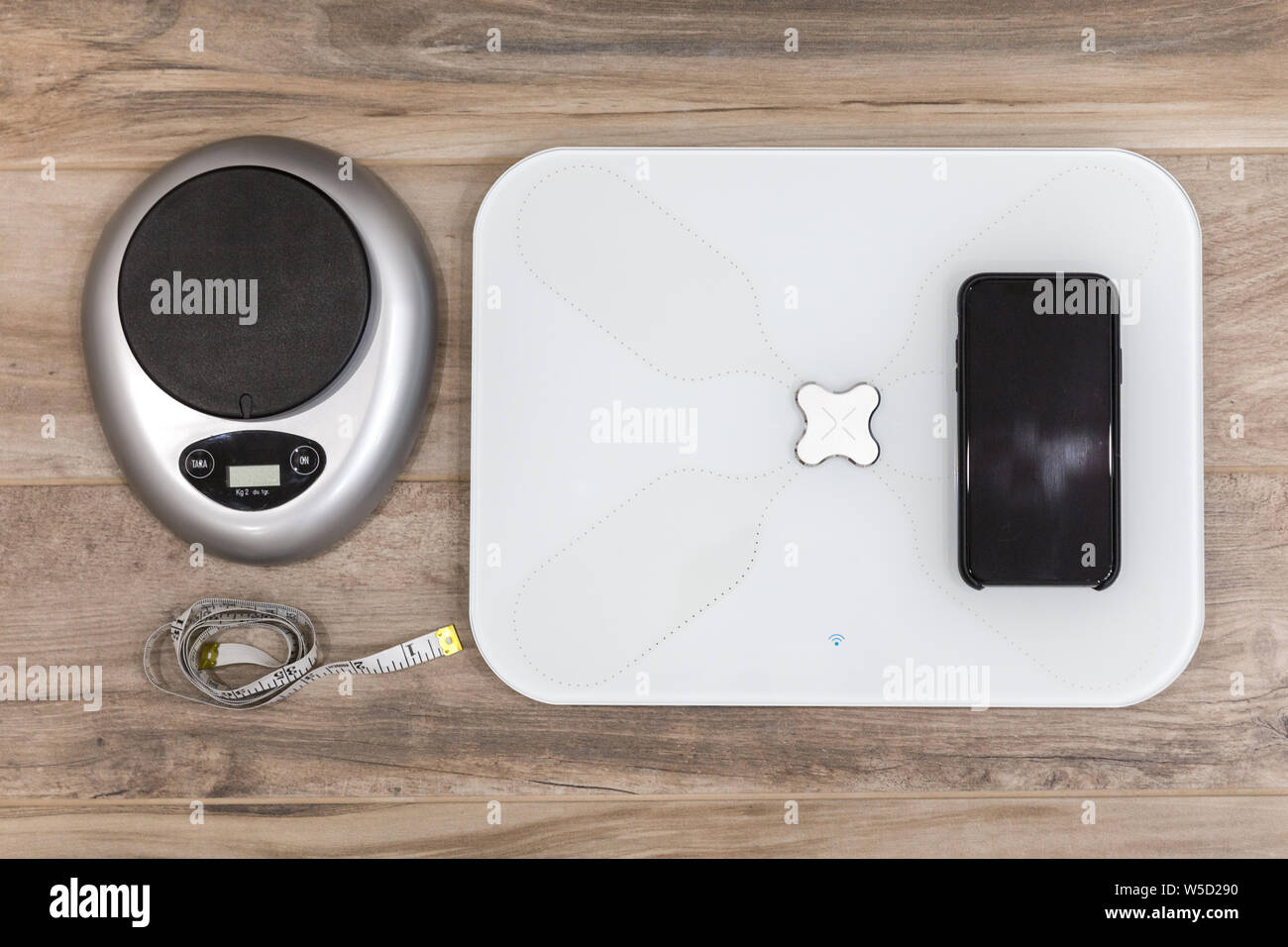 Smart scale standing on a floor connected to smartphone Stock Photo - Alamy