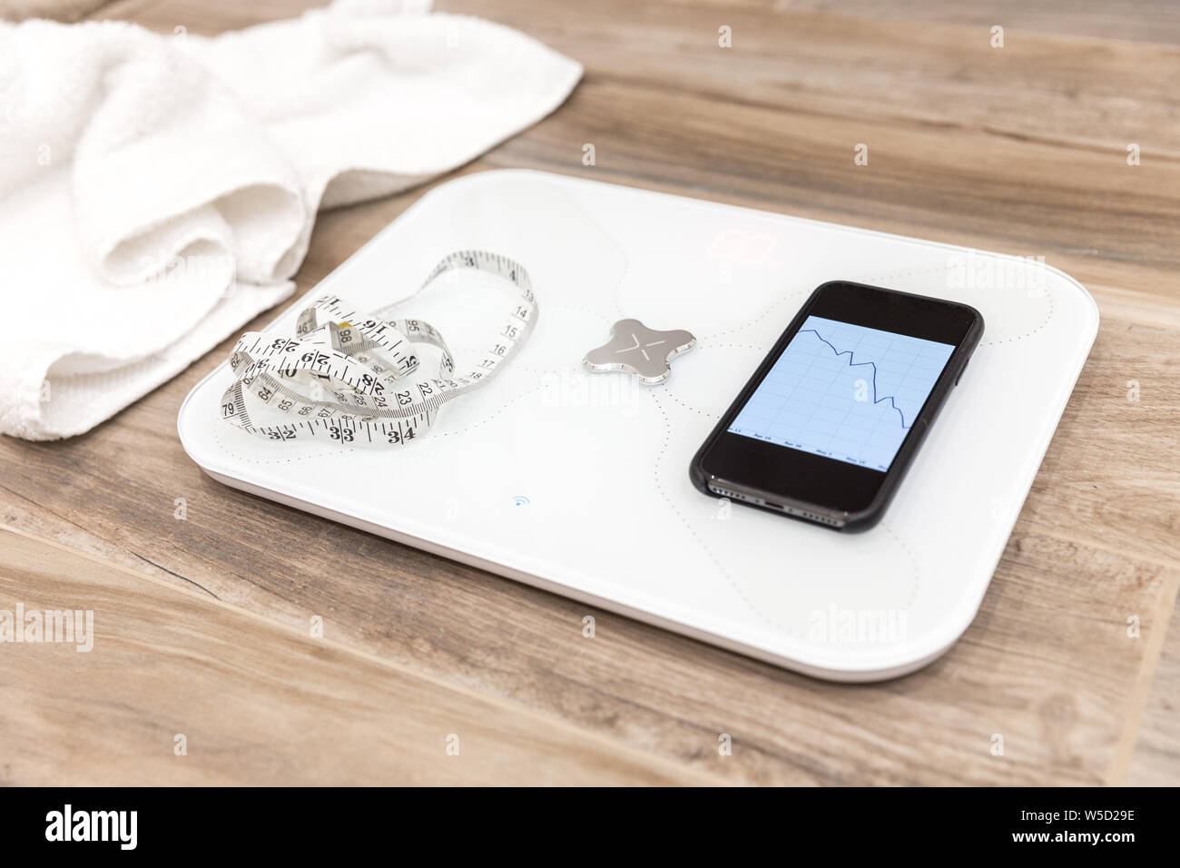 Smart scale standing on a floor connected to smartphone Stock Photo - Alamy
