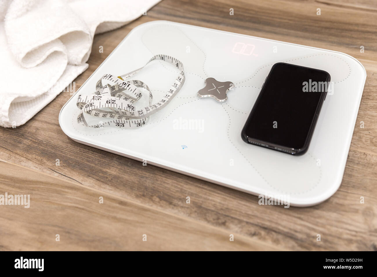 Smart scale standing on a floor connected to smartphone Stock Photo - Alamy