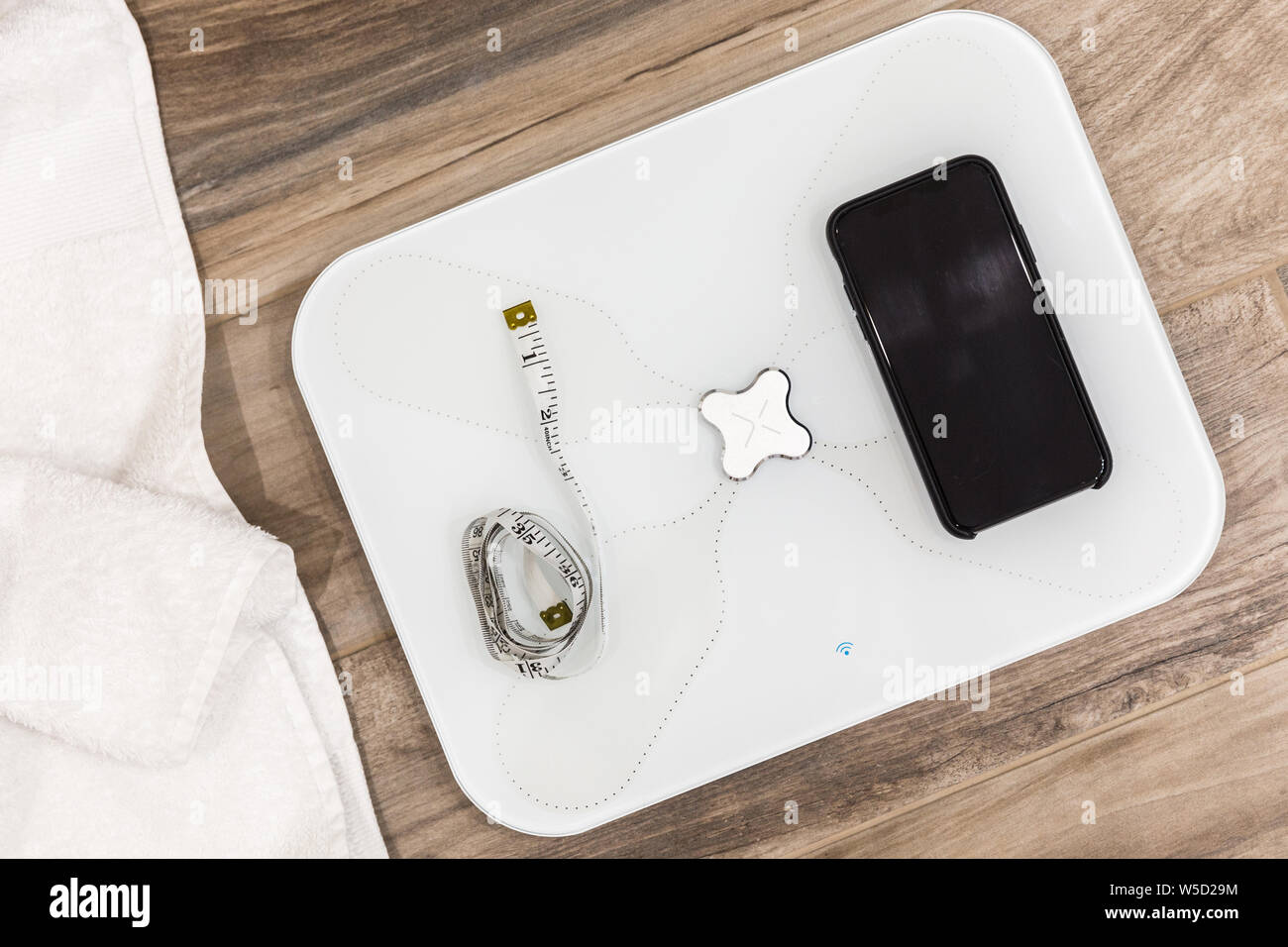 Smart scale standing on a floor connected to smartphone Stock Photo - Alamy