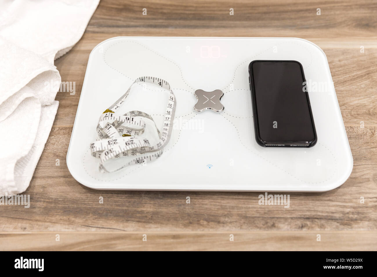 Smart scale standing on a floor connected to smartphone Stock Photo - Alamy