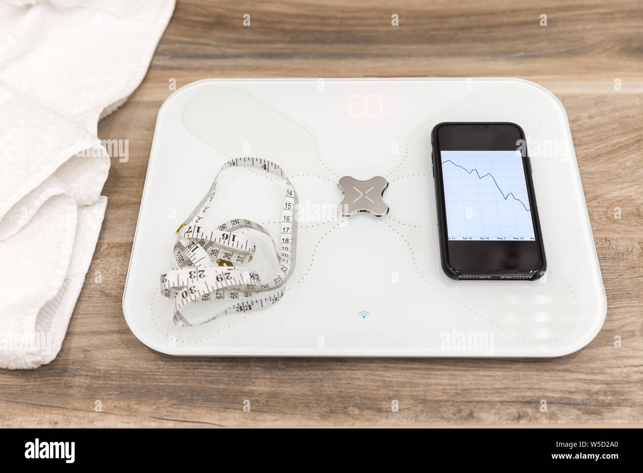 Smart scale standing on a floor connected to smartphone Stock Photo - Alamy