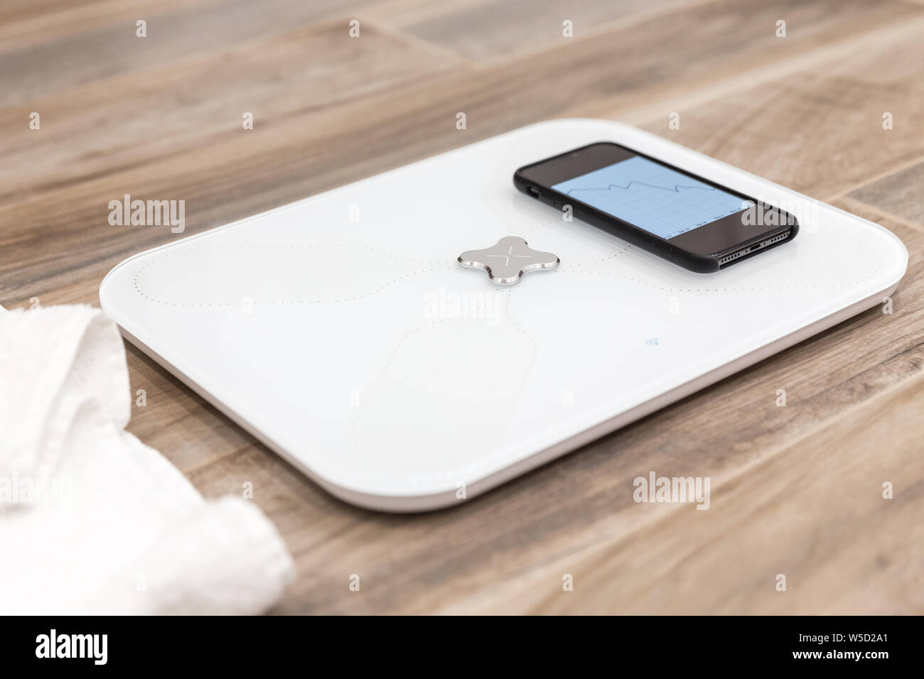 Smart scale standing on a floor connected to smartphone Stock Photo - Alamy