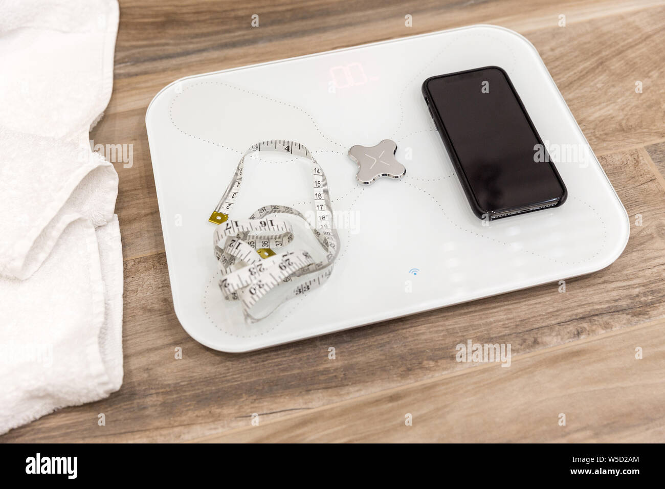 Smart scale standing on a floor connected to smartphone Stock Photo - Alamy