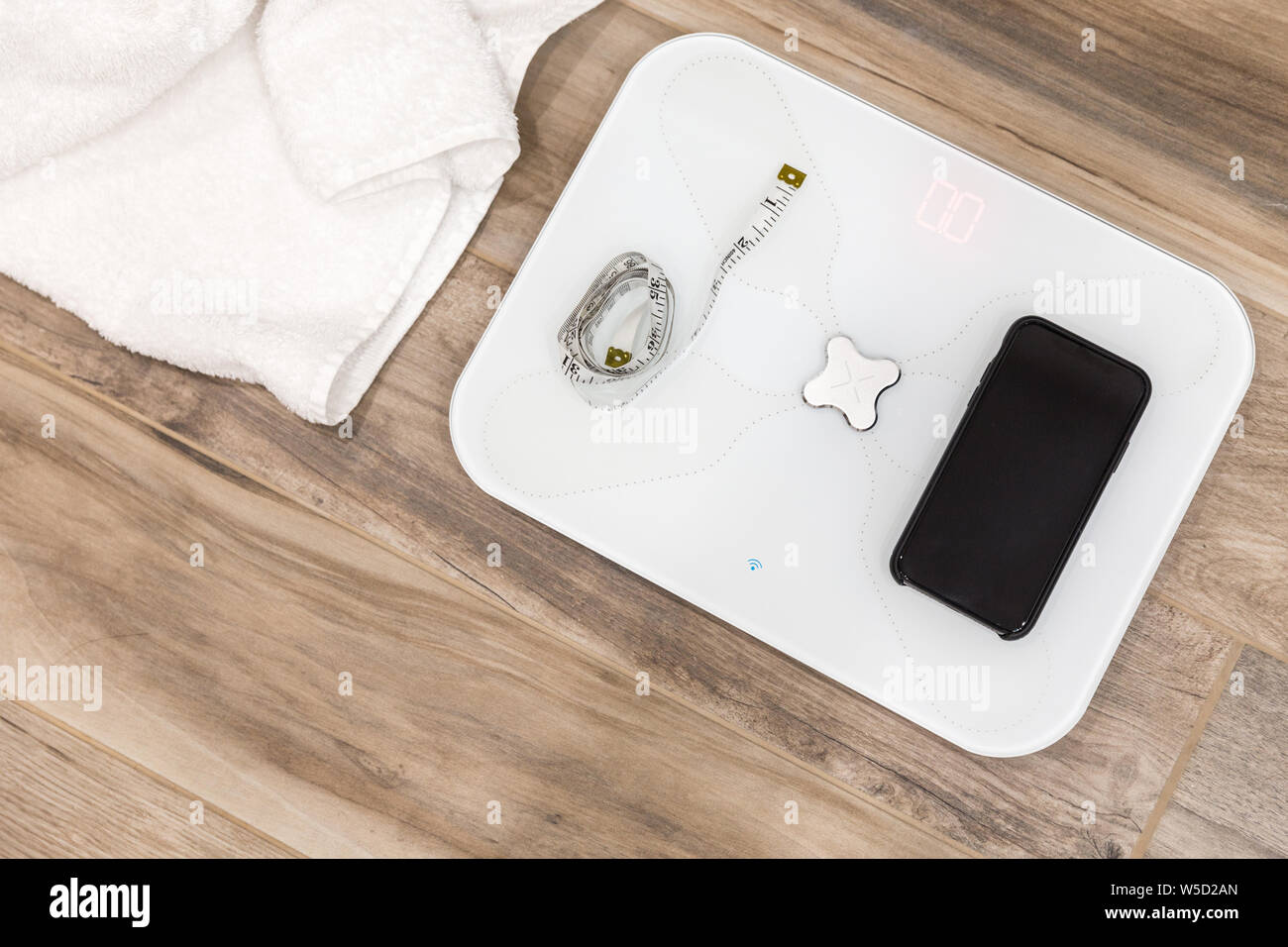 Smart scale standing on a floor connected to smartphone Stock Photo - Alamy