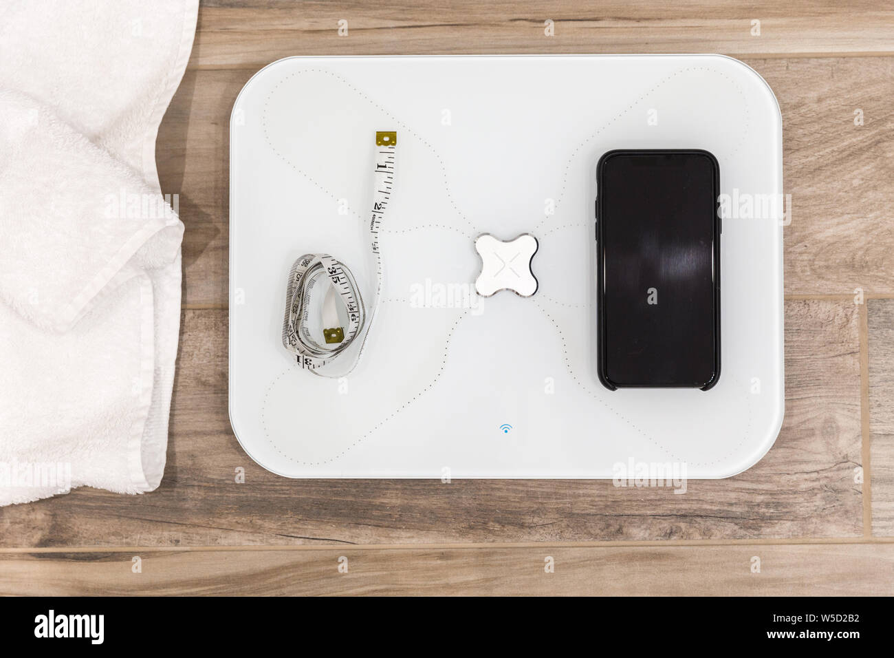 Smart scale standing on a floor connected to smartphone Stock Photo - Alamy