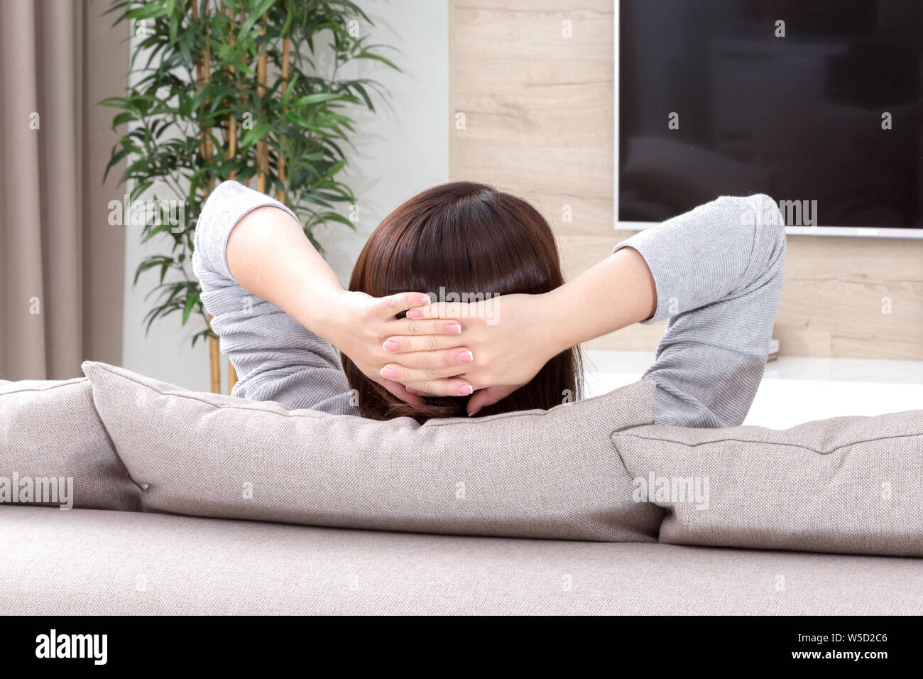 Young woman watching TV in the room Stock Photo - Alamy
