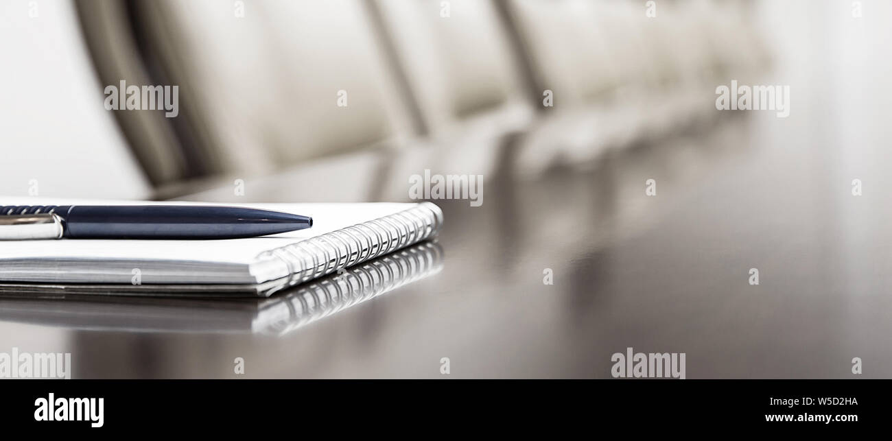 notepad on a table in meeting room Stock Photo - Alamy