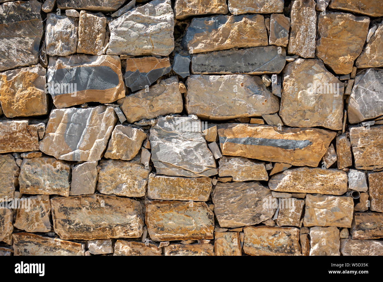 Stone block built wall using random size blocks Stock Photo - Alamy
