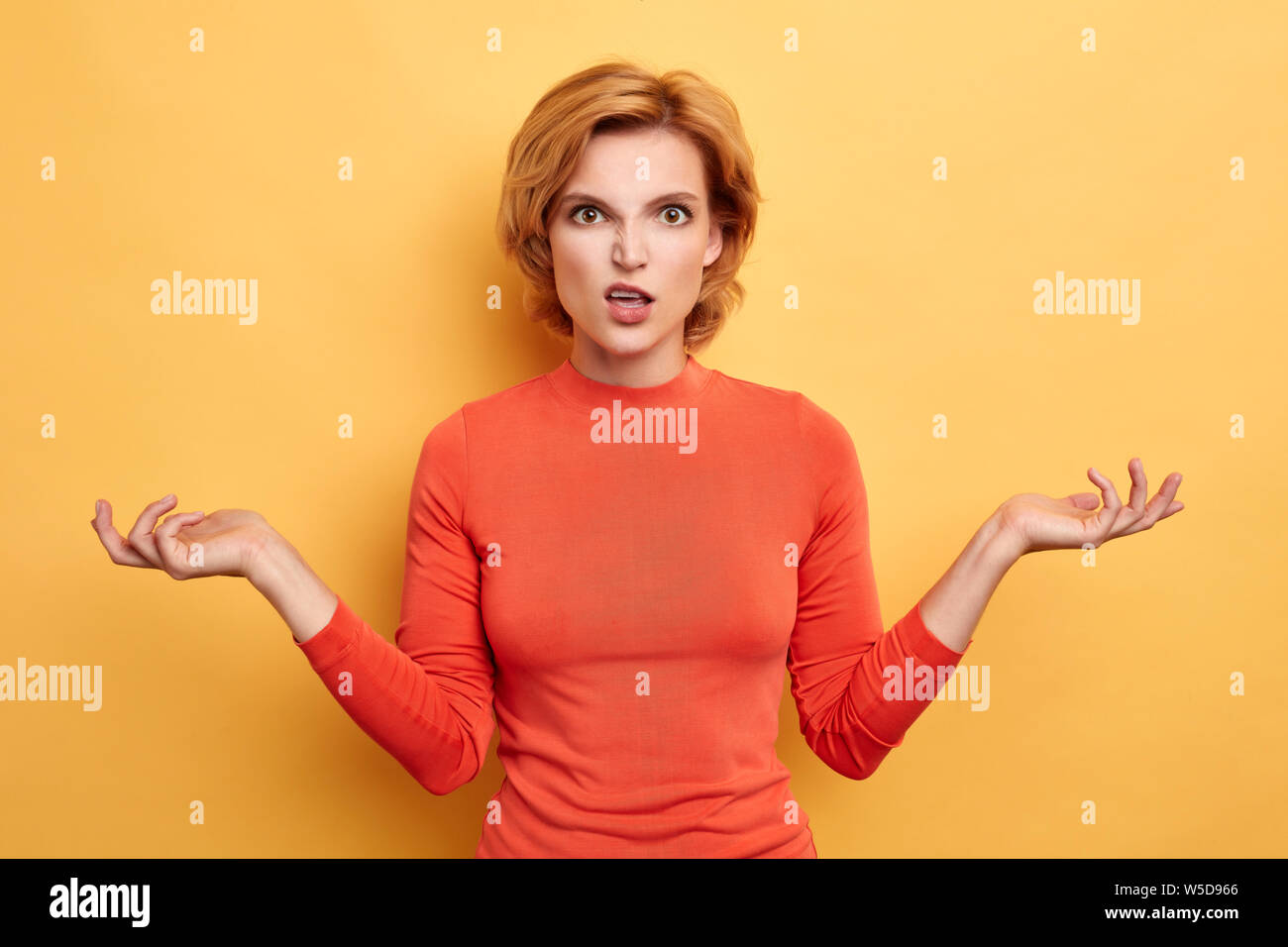 angry irritated woman with hands raised having an argument with ...