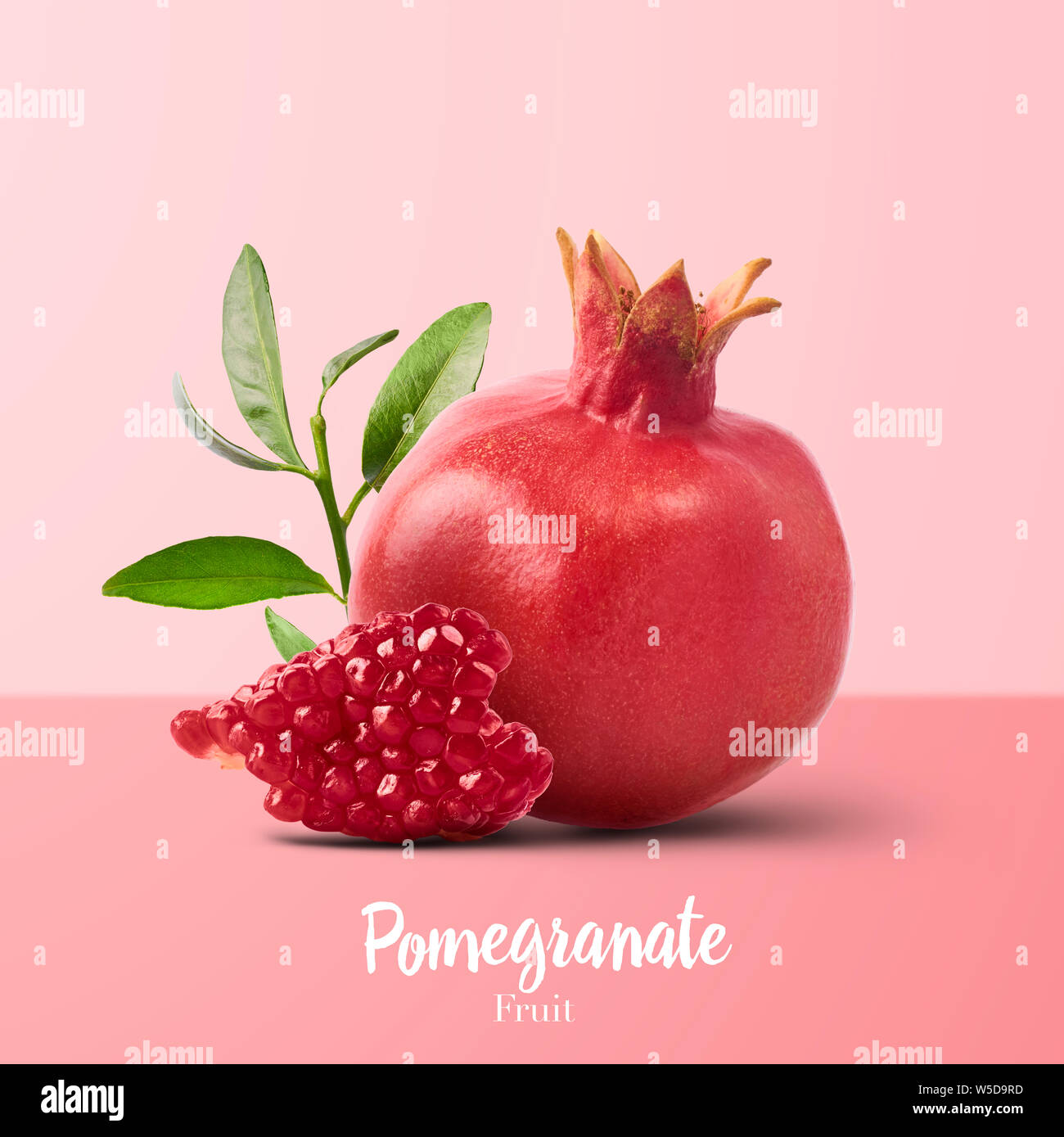 Fresh ripe pomegranate with green leaves isolated on pastel pink ...