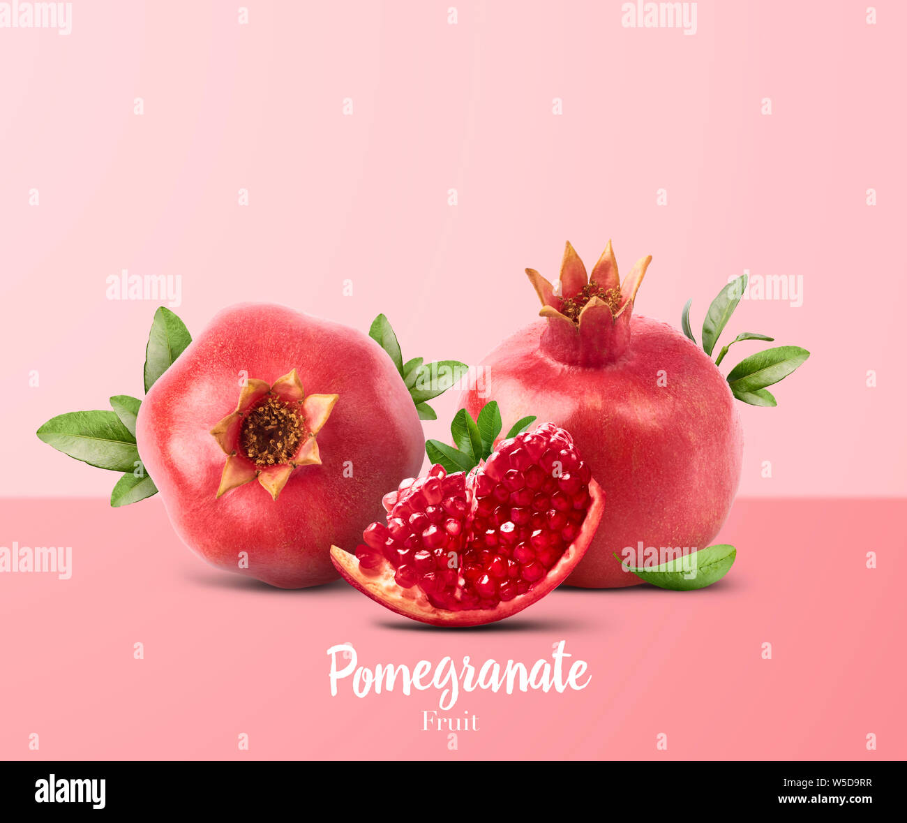 Fresh ripe pomegranate with green leaves isolated on pastel pink ...