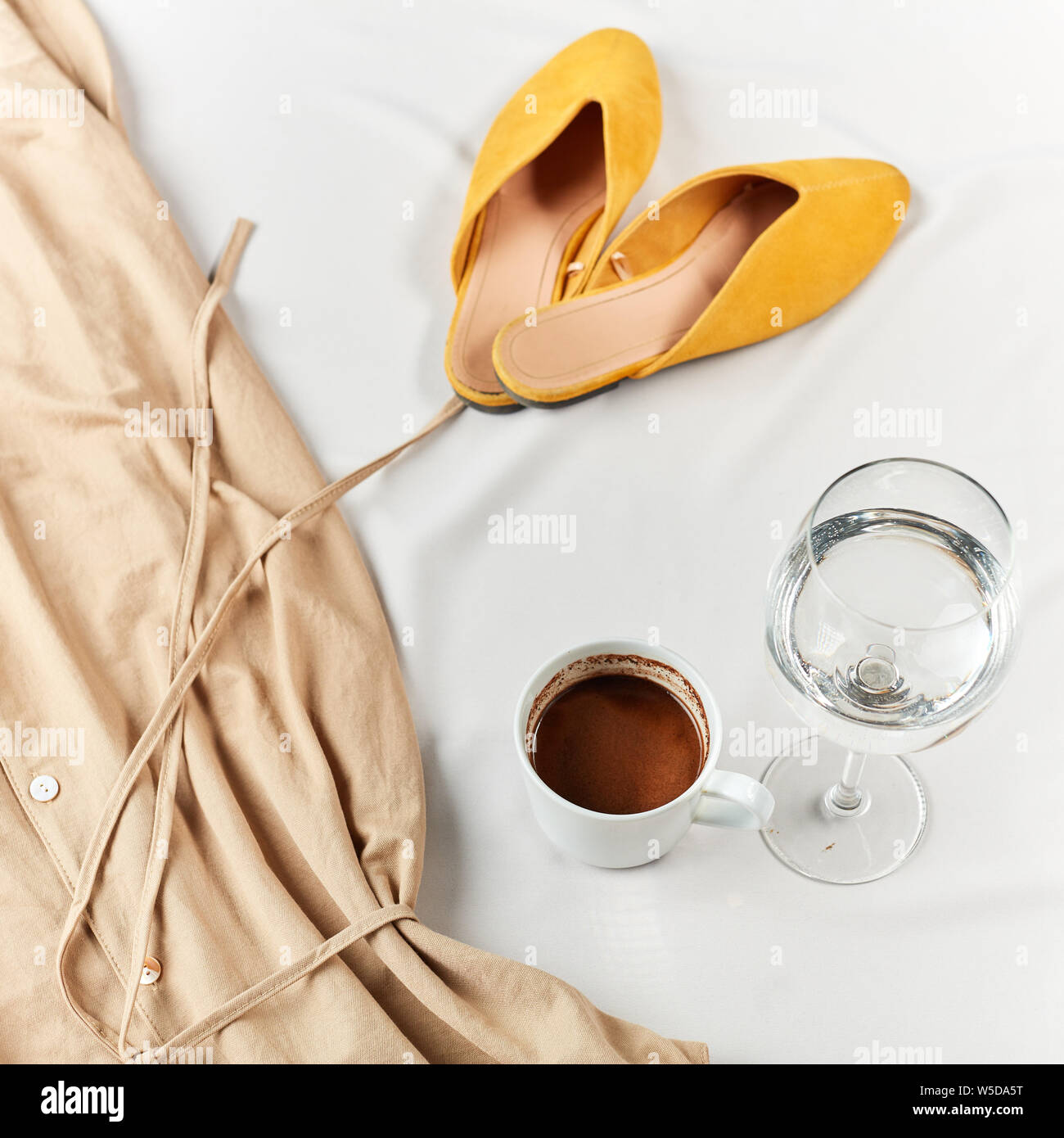 female clothes set with glass of water and tea. top view photo Stock ...