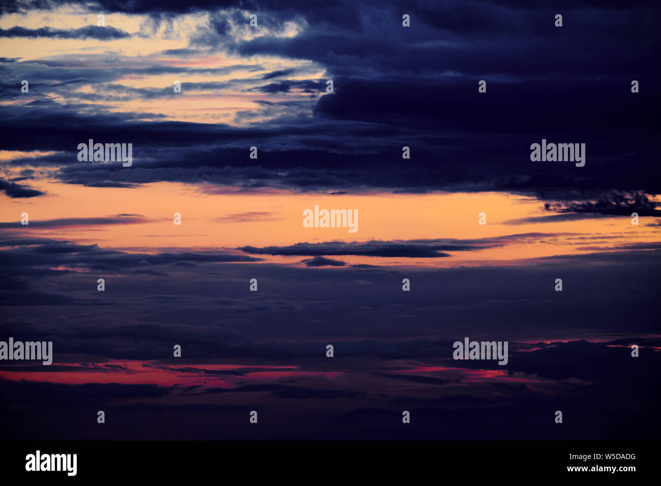 Beautiful sunset - dark sky with clouds and sunlight Stock Photo - Alamy
