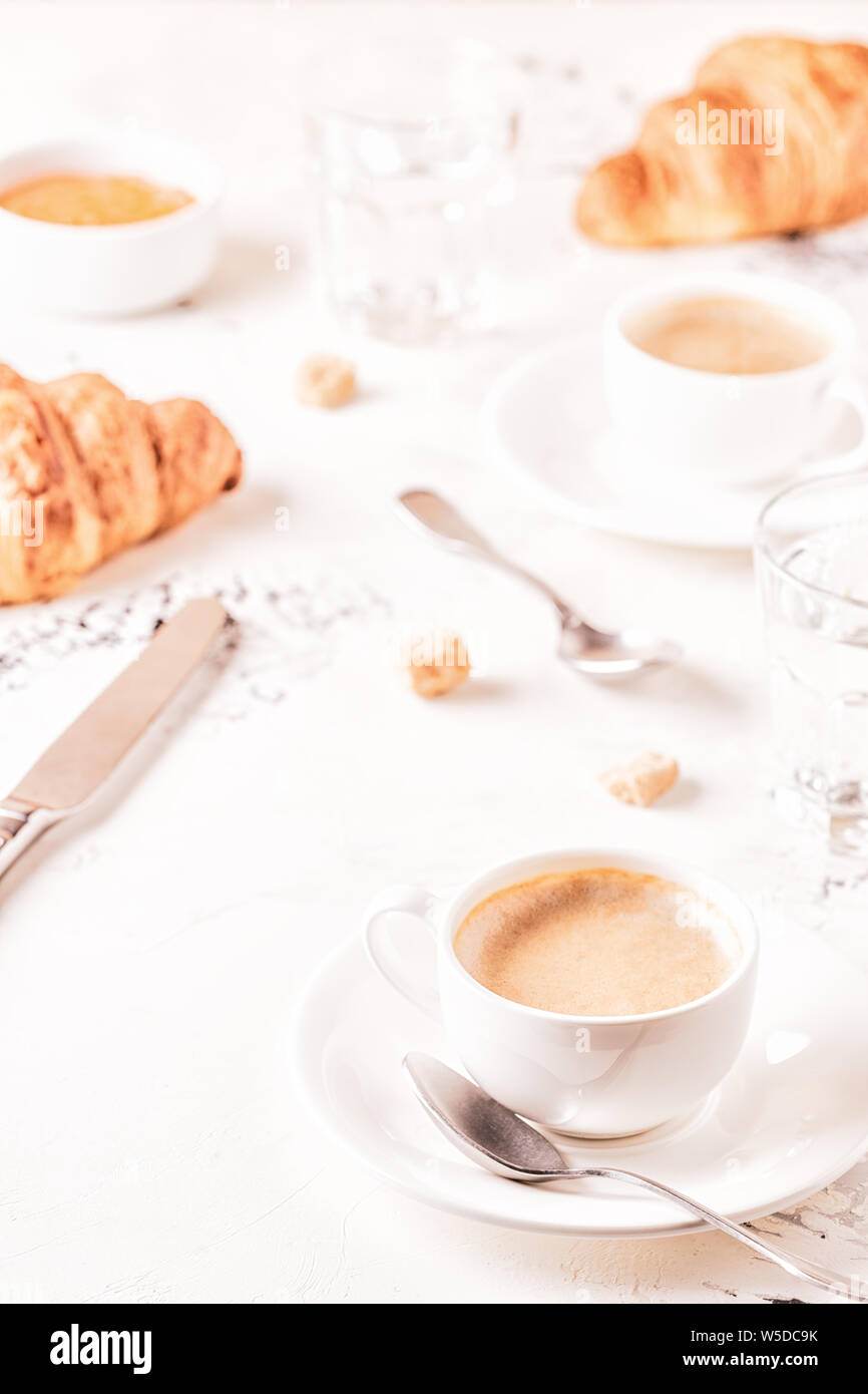 Traditional breakfast with fresh croissants on white background ...