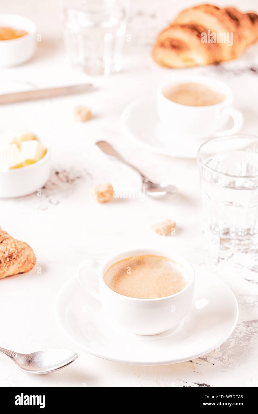 Traditional breakfast with fresh croissants on white background ...