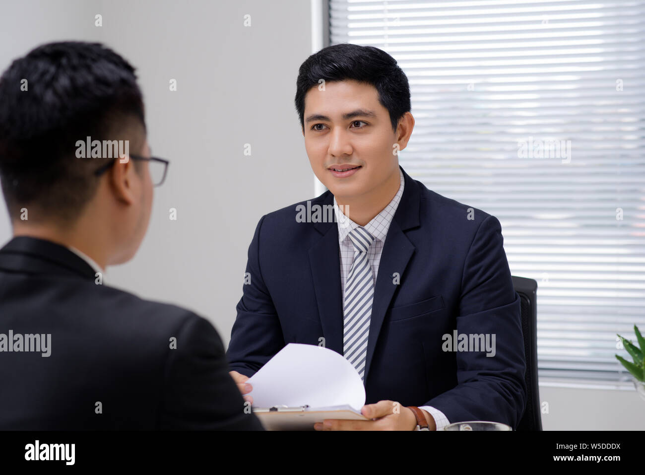 Job interview of two business professionals. Greeting new colleague ...