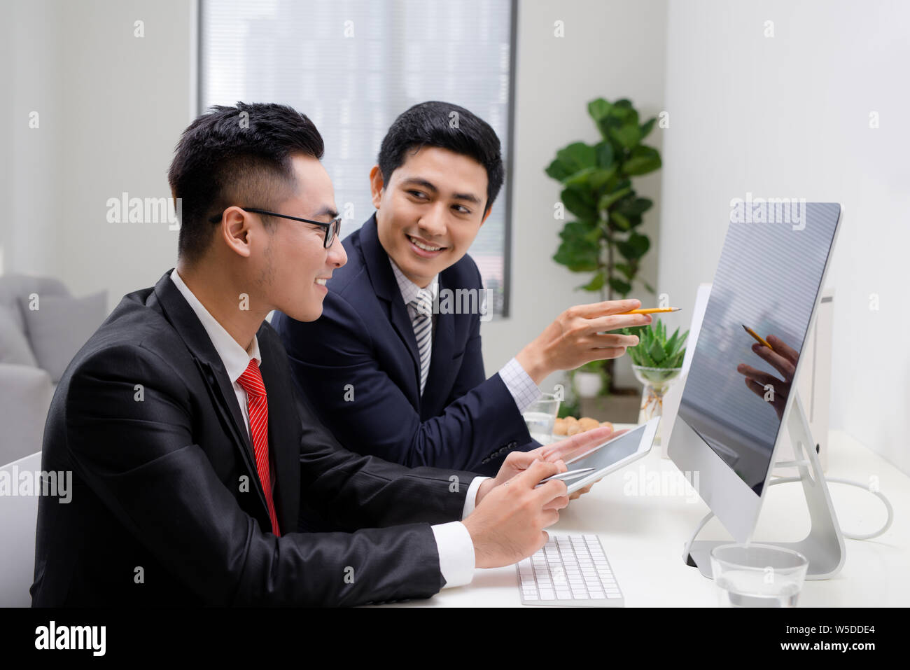 Startup business partners working together in desktop Stock Photo - Alamy