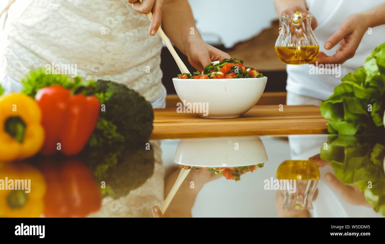 Closeup of human hands cooking in kitchen. Mother and daughter or two ...