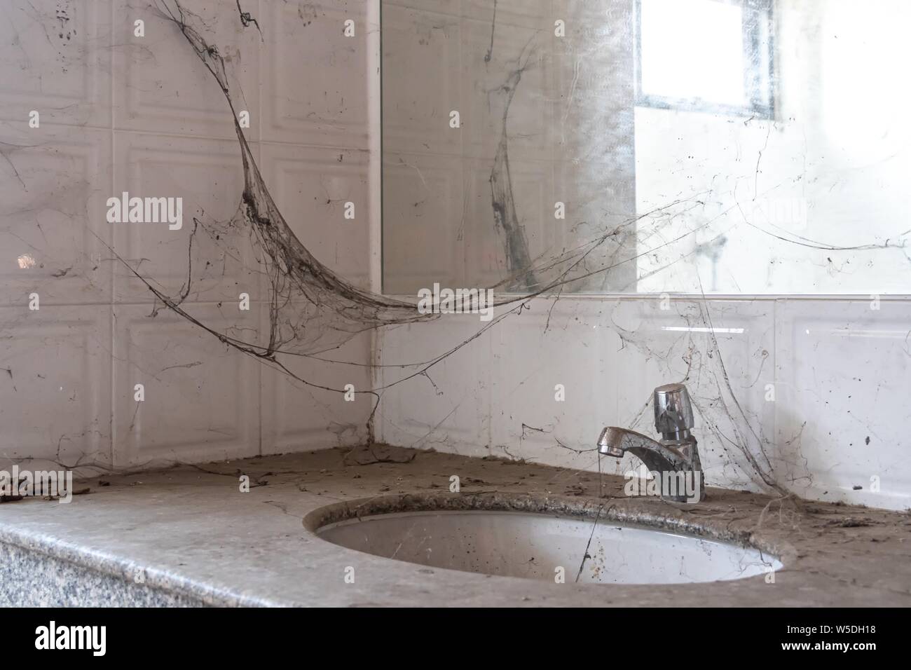 Abandoned toilet. a lot of cobwebs and garbage in abandoned toilet ...