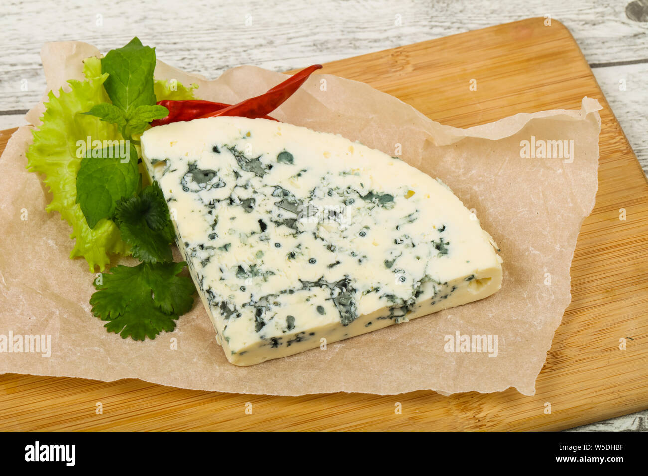 Blue cheese slice with salad leaves Stock Photo - Alamy