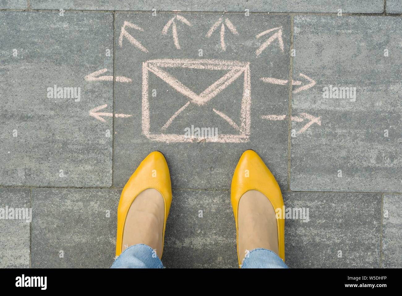 Female feet with abstract envelope message letter with arrows in ...