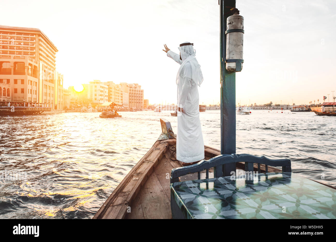 Arabic man with traditional clothes on the top of the boat, on the ...
