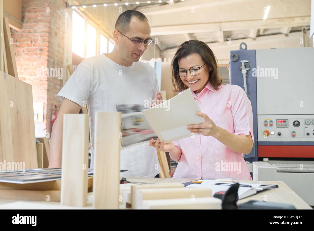 Couple man and woman designer, client, carpenter, engineer choosing ...