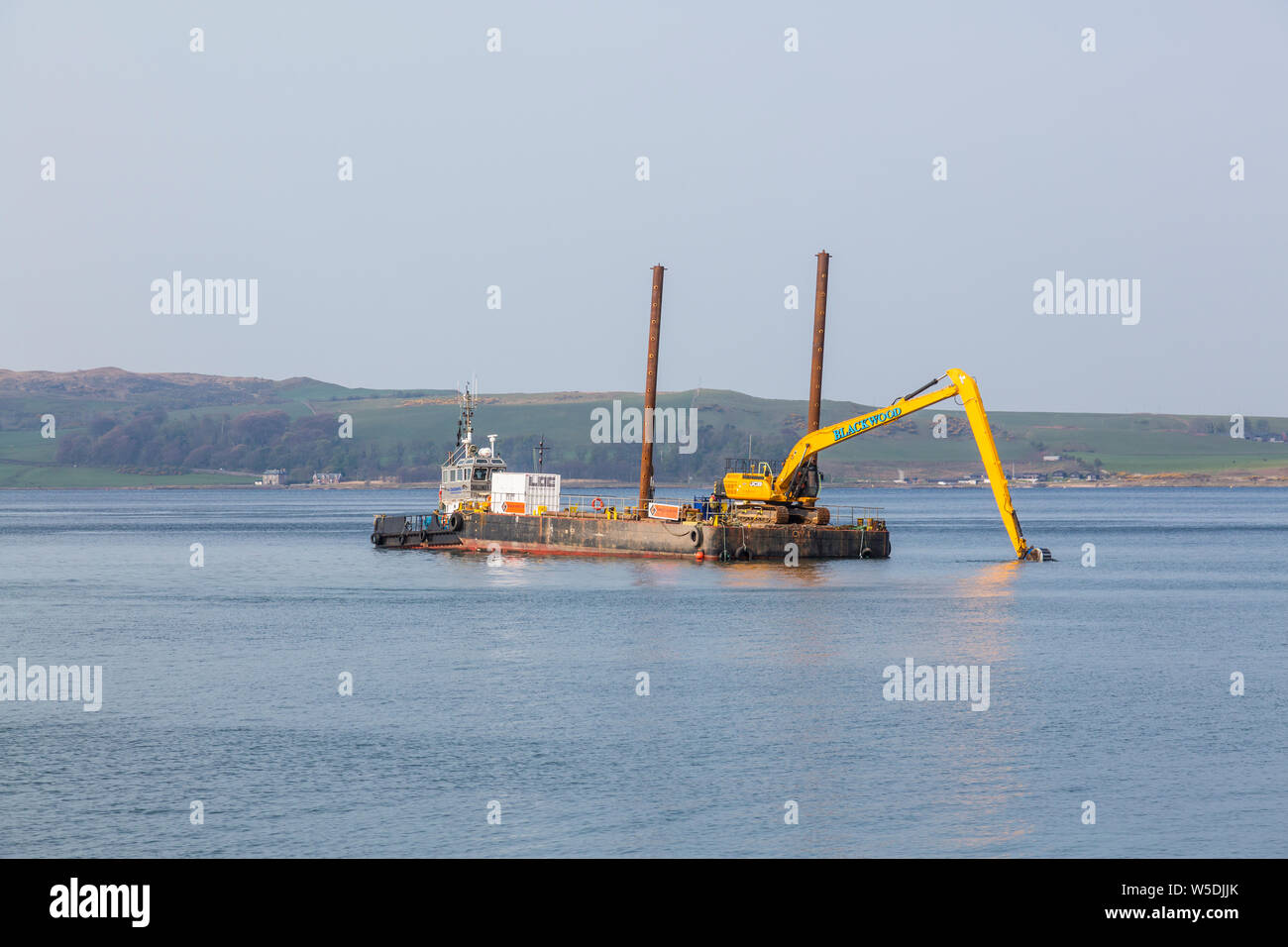 A long reach digger working from a barge to install a longer screened ...