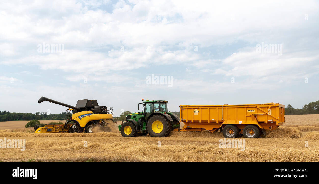 Cheltenham, Gloucestershire, England, UK. Combine harvester offloading ...