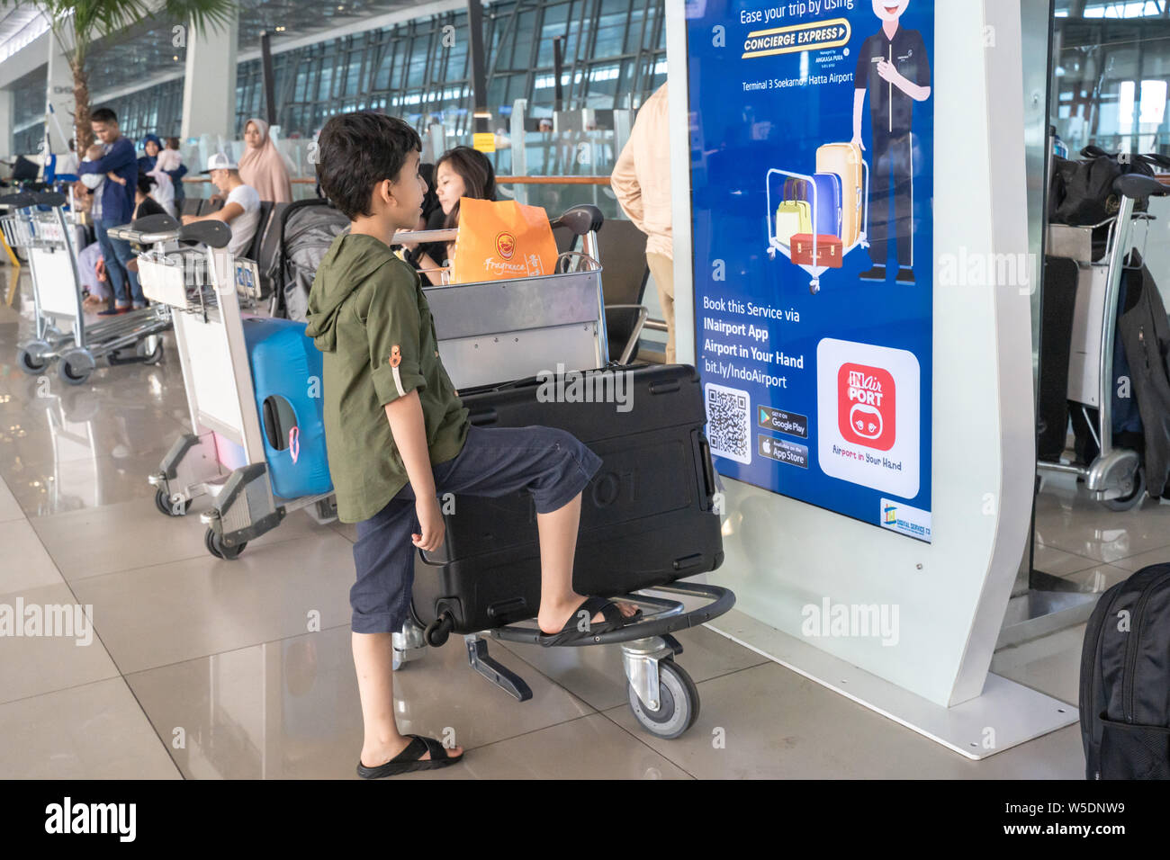 Young boy interacting with interactive information stand in Soekarno ...