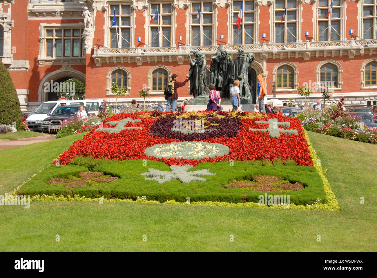 Flower beds in front of Town Hall, Calais, France with bronze of ...