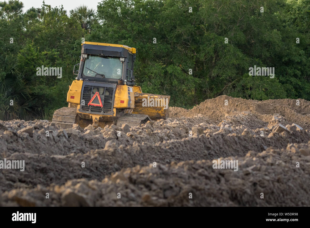 Construction Vehicle - Front Loader. Loader pushes dirt to make room ...