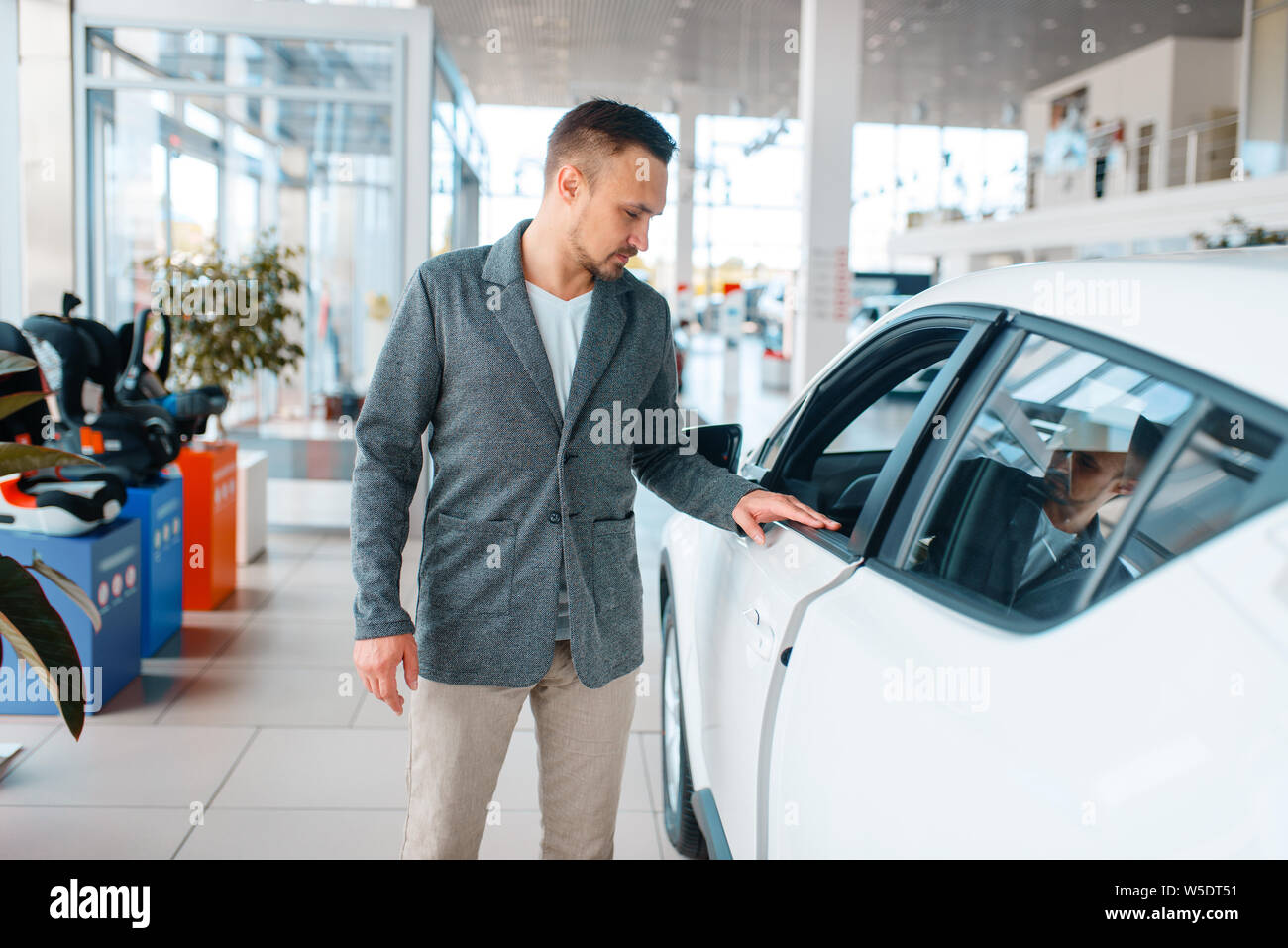 Man buying new car in showroom Stock Photo - Alamy