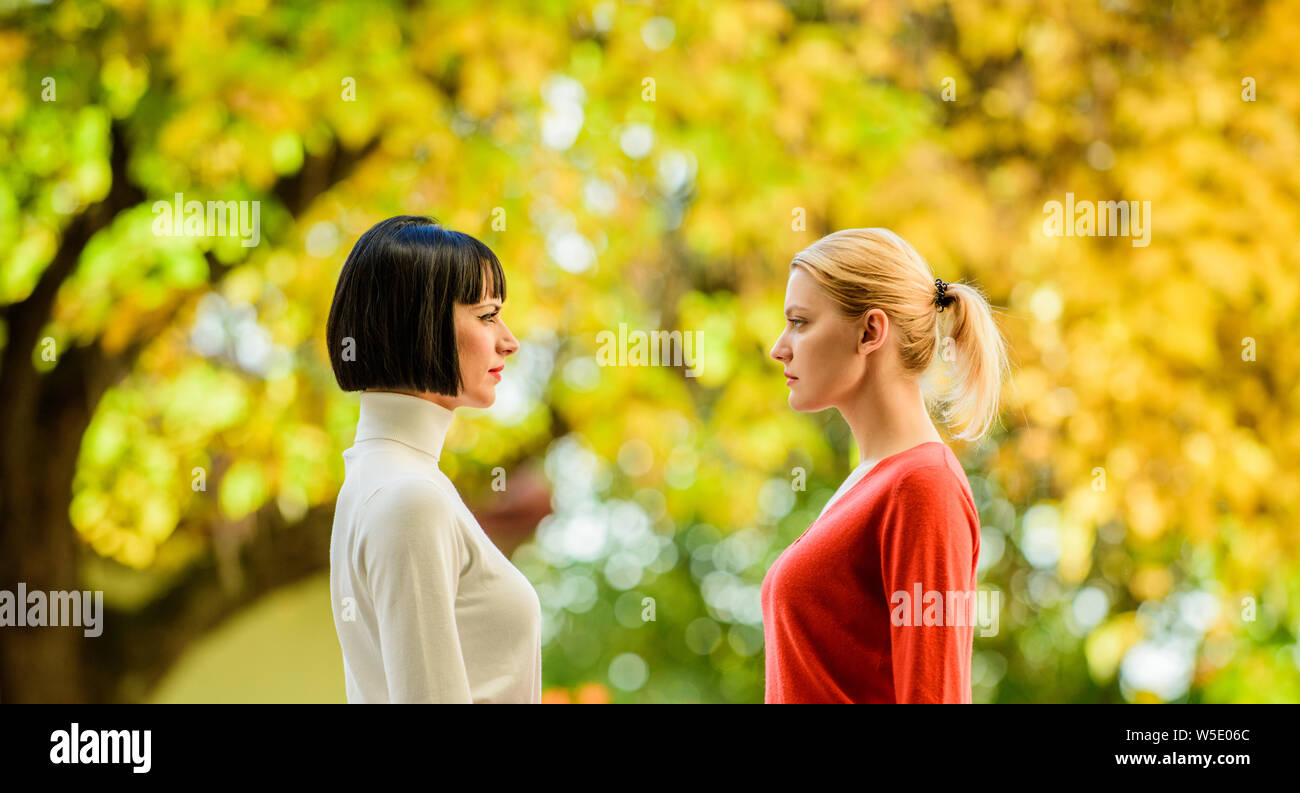 Pretty girls friends sisters. Eye contact. Women looking at each other ...