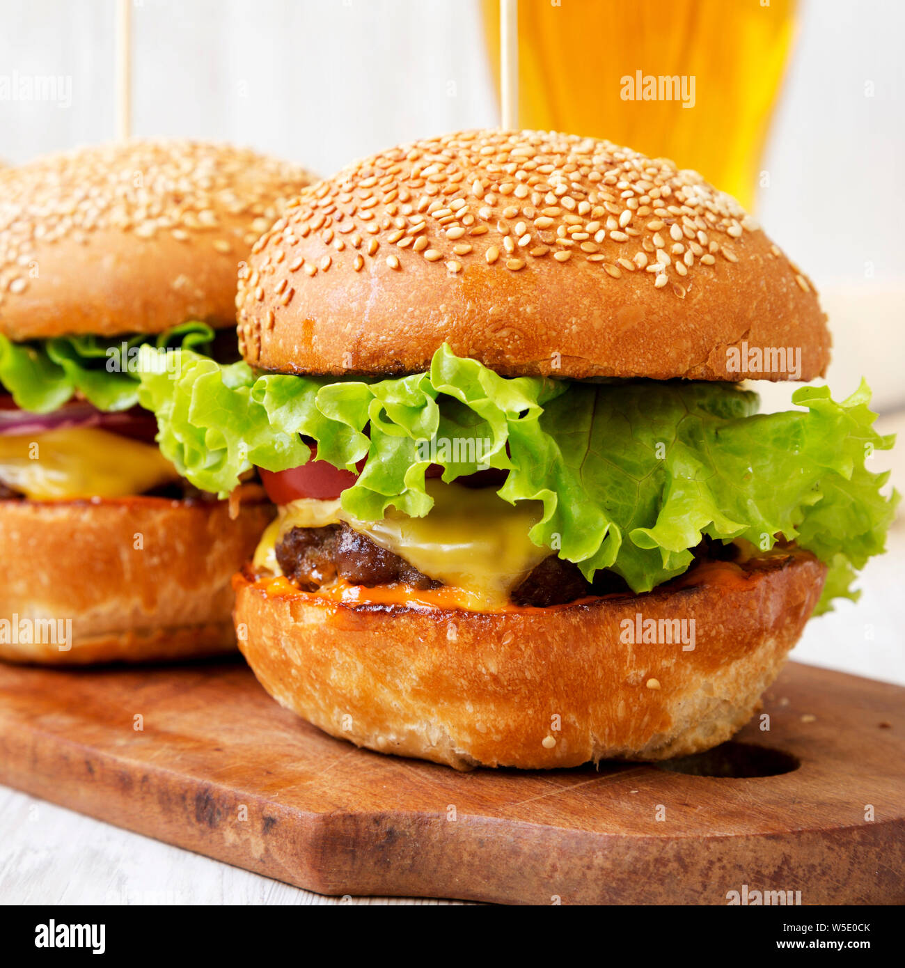 Homemade cheeseburgers and glass of cold beer, side view. Closeup Stock ...