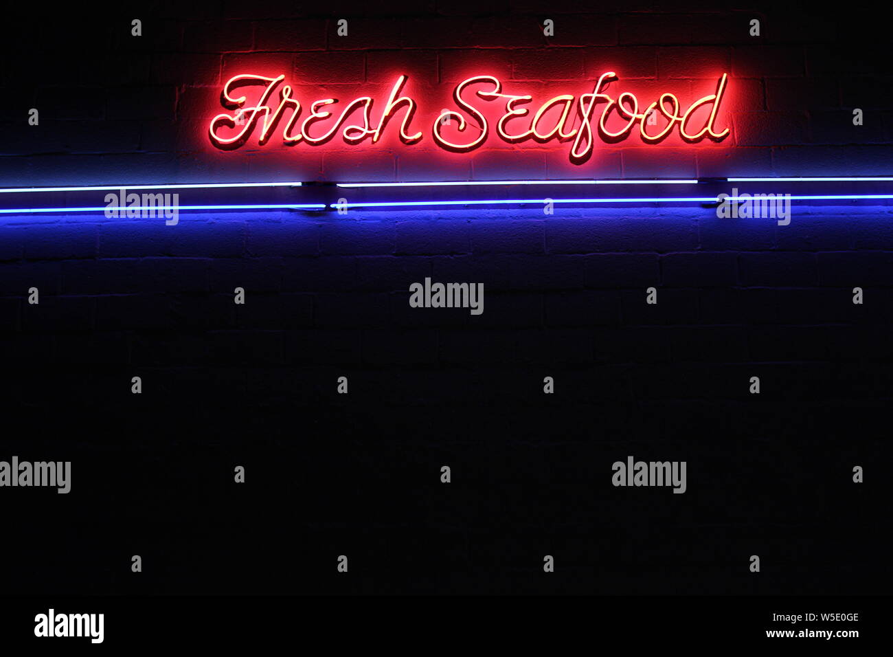 Bright neon sign writing fresh seafood Stock Photo - Alamy