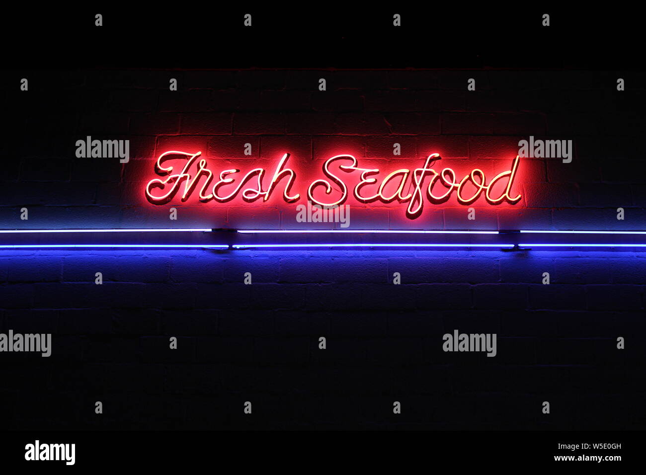 Bright neon sign writing fresh seafood Stock Photo - Alamy