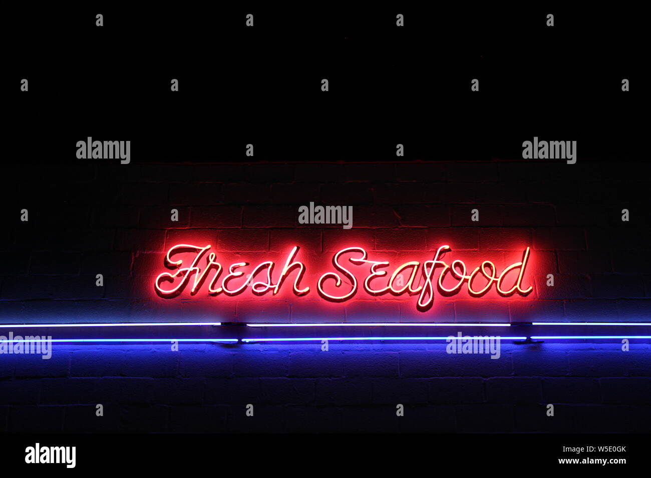 Bright neon sign writing fresh seafood Stock Photo - Alamy