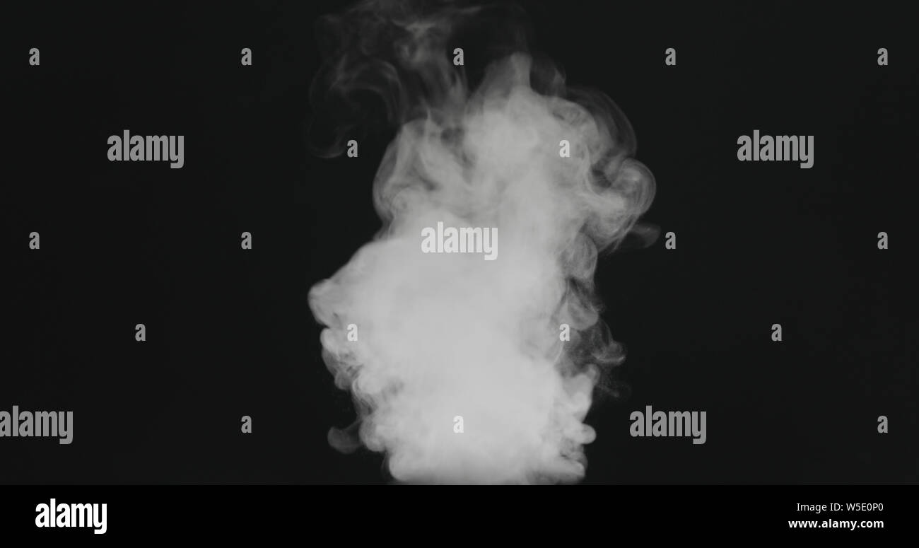water vapor stream comes from below over black background with motion ...