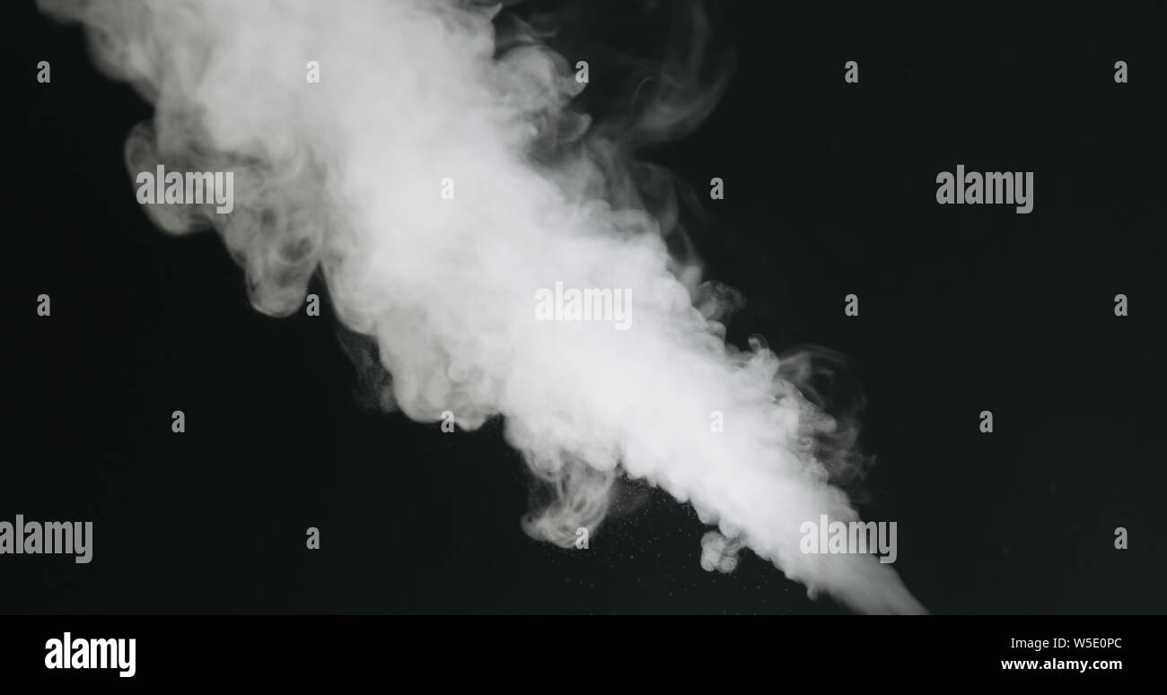 water vapor stream comes from below over black background with motion ...